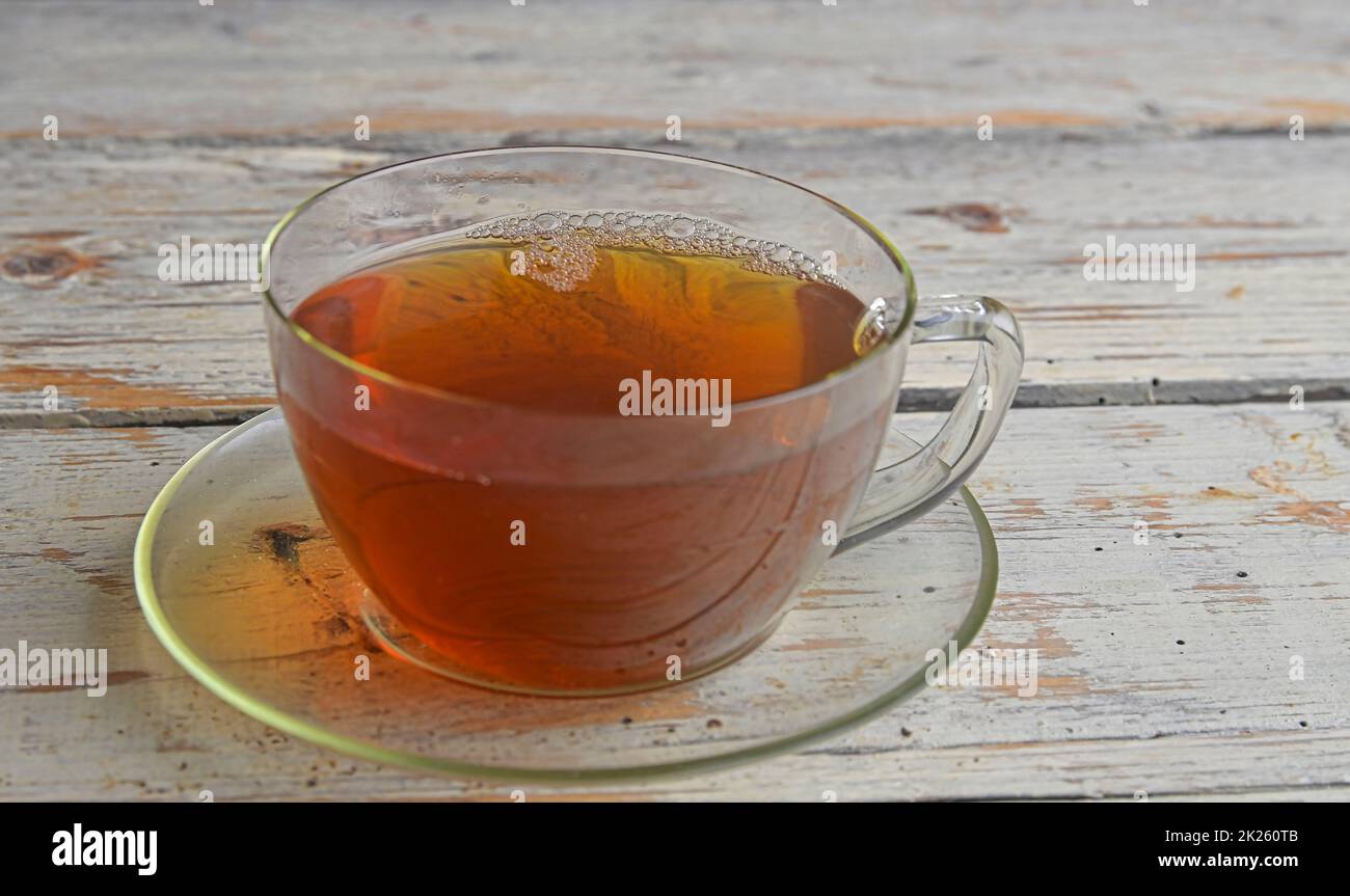 Delicious black tea in a transparent cup. Cup of tea on wooden rustic ...