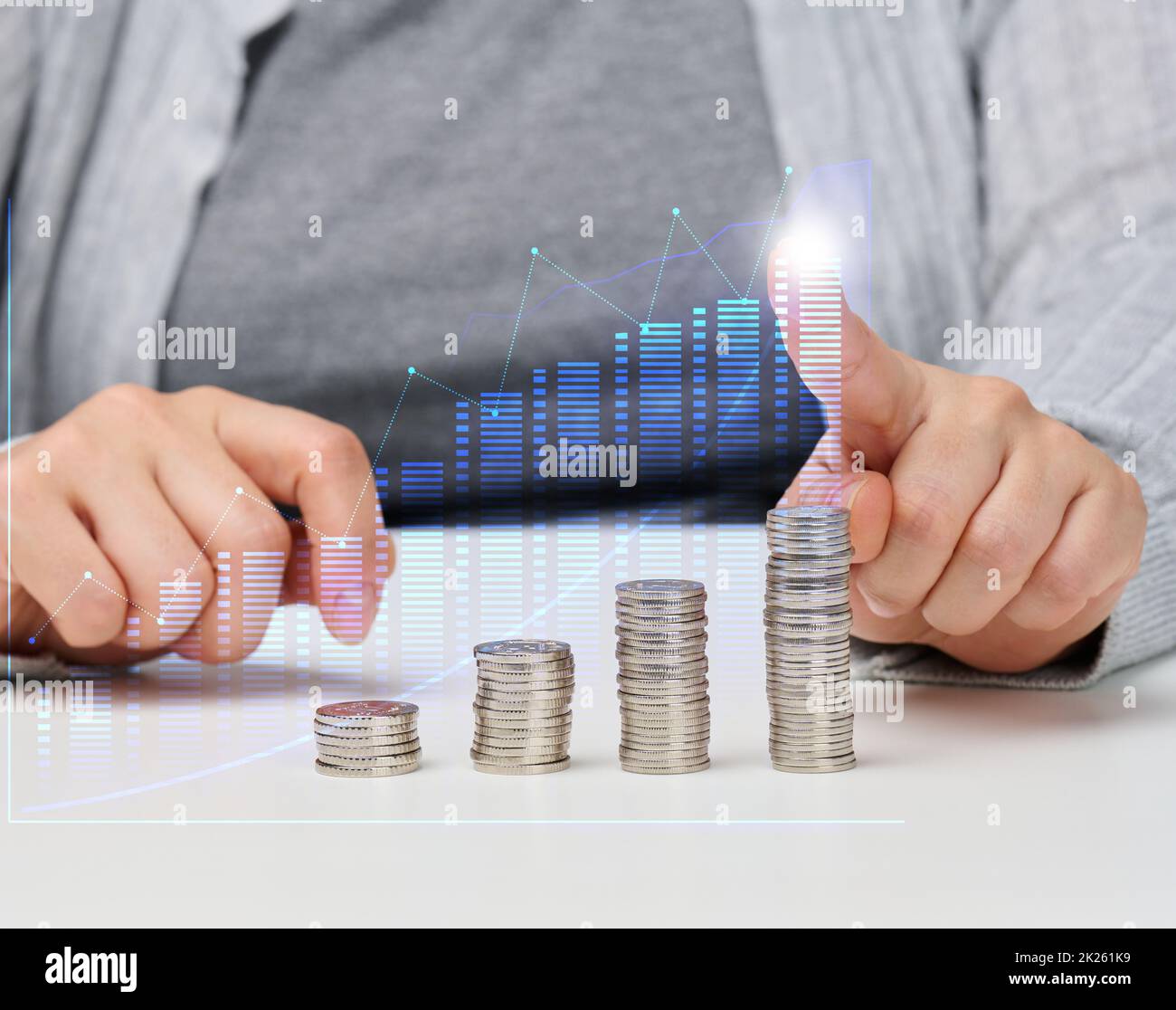 a stack of iron coins and a graph with rising indicators. Business ...