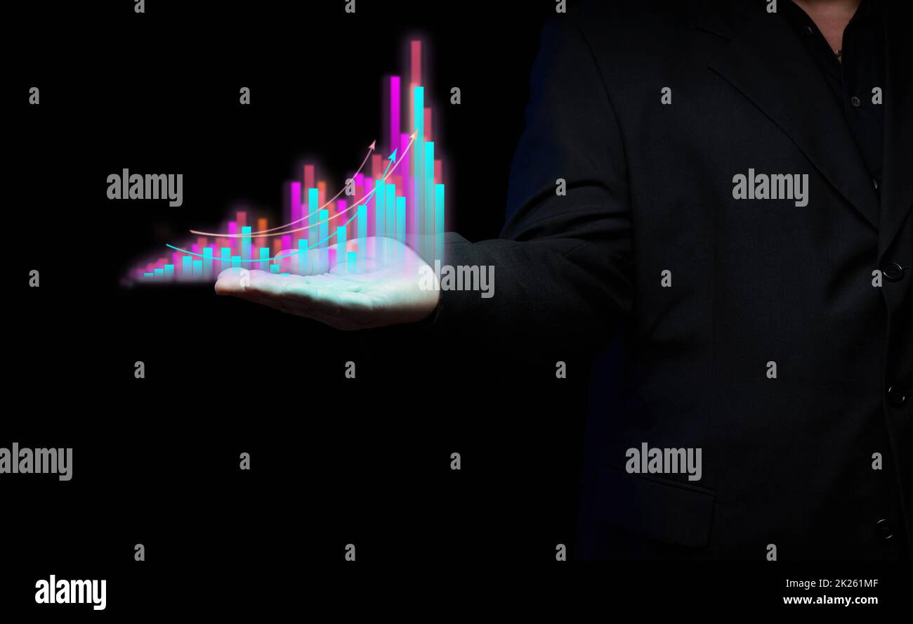 holographic chart growth indicators and a businessman in a black suit ...