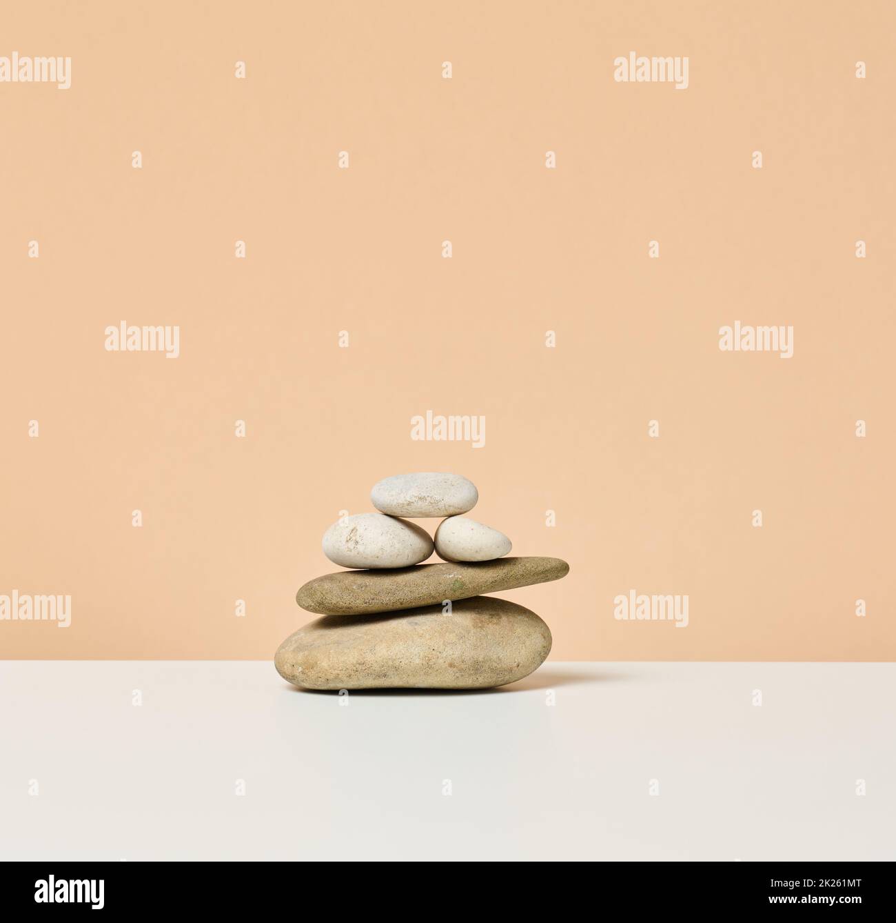 stack of round stones on a beige background. Scene for demonstration of ...