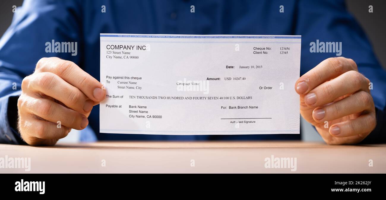Holding Paycheck Or Payroll Check Or Insurance Cheque Stock Photo - Alamy