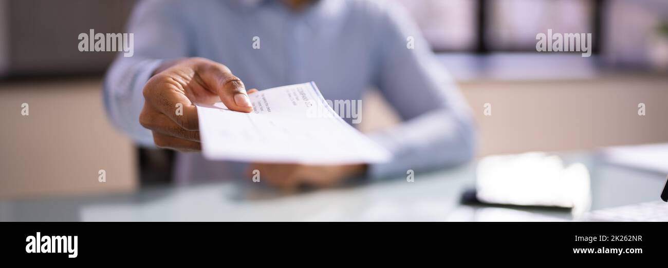 African Business Man Giving Paycheck Stock Photo - Alamy