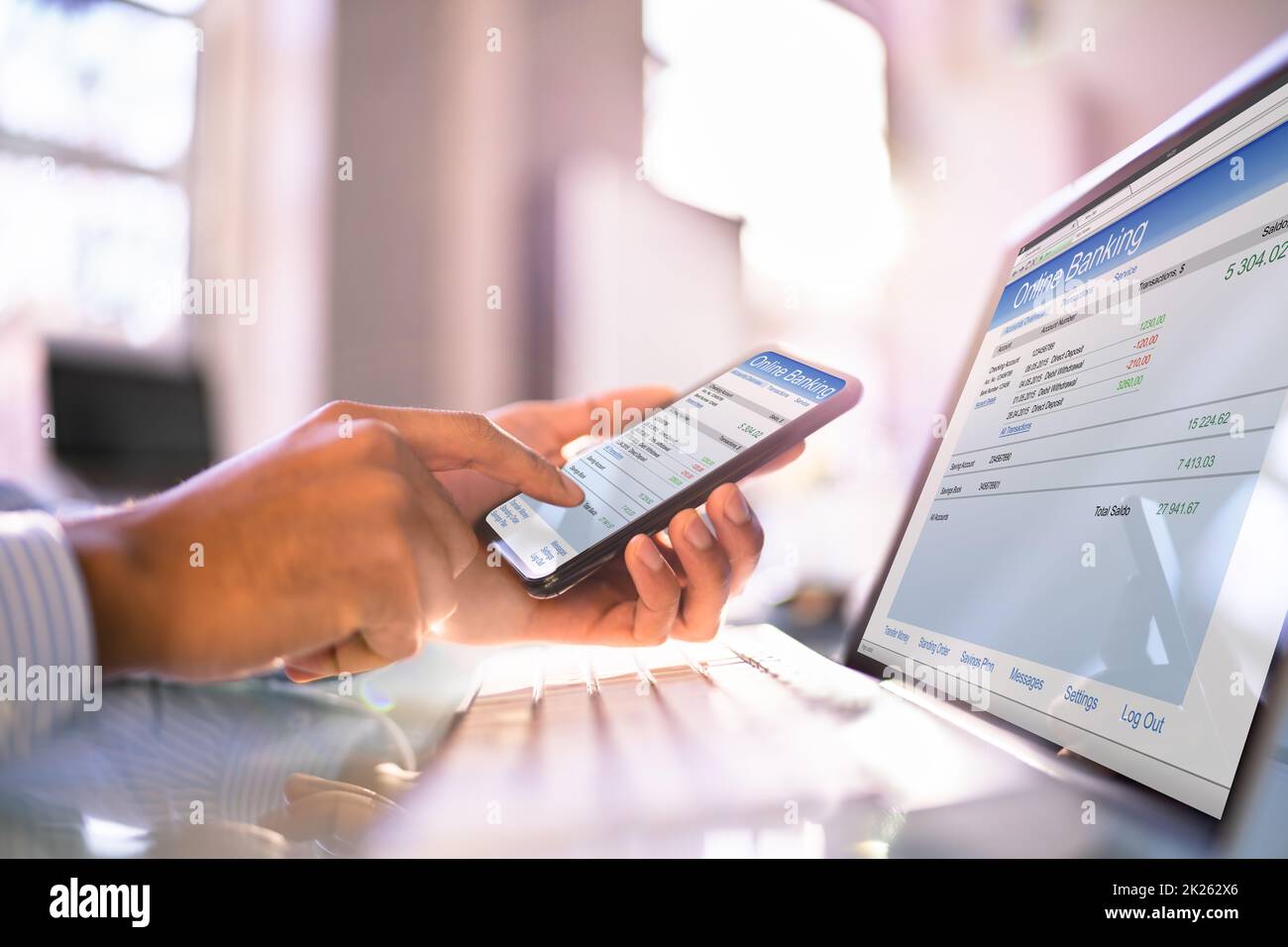Online Banking On Mobile Phone And Hybrid Laptop Stock Photo - Alamy