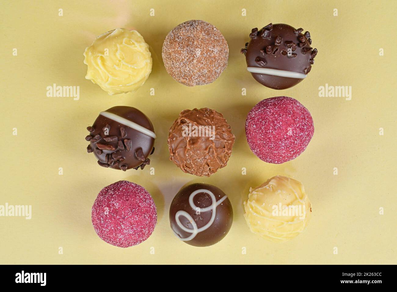 Chocolate pralines top view stock images. Chocolate candies on a pastel ...