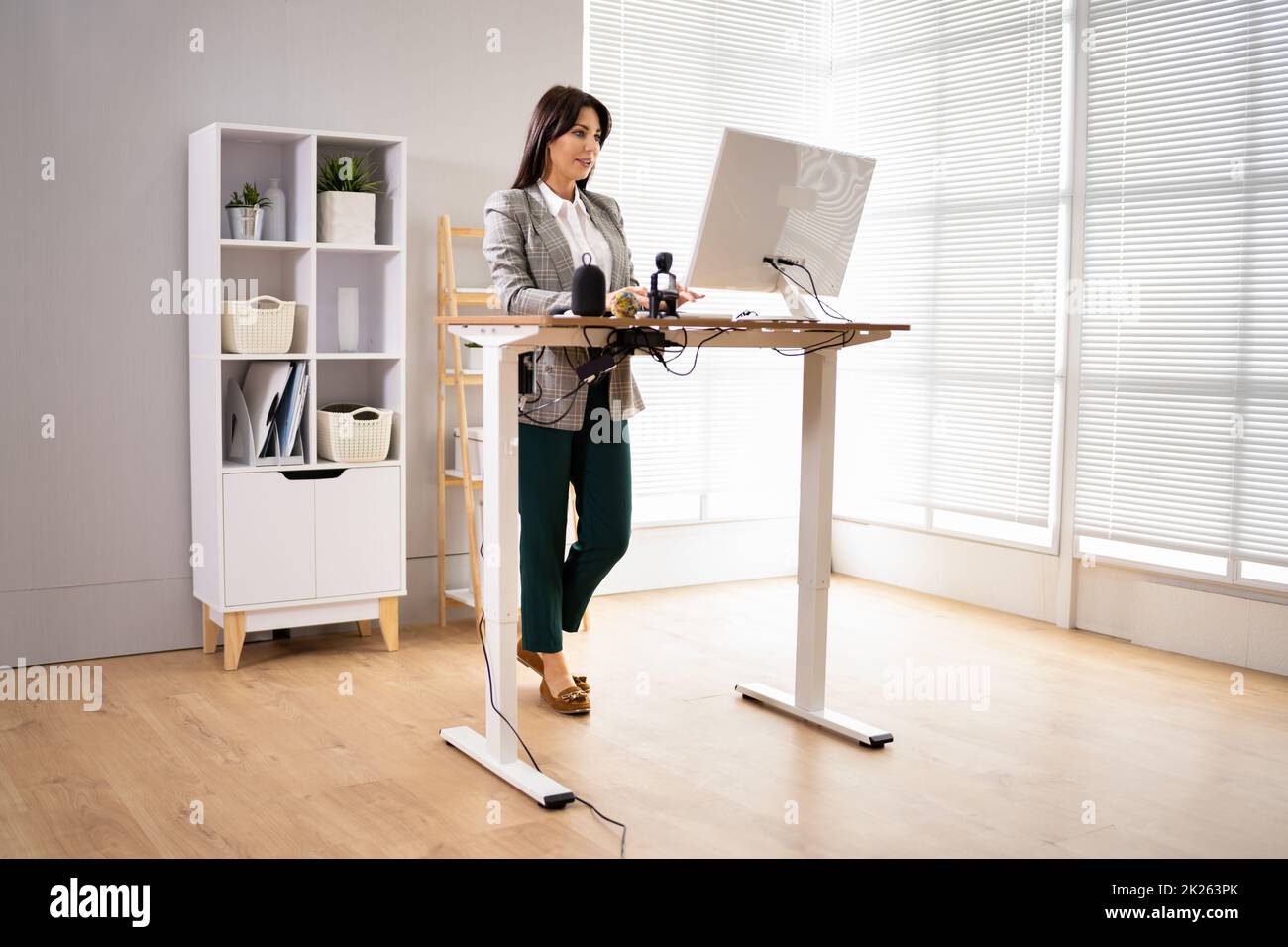 Adjustable Height Desk Stand In Office Stock Photo - Alamy