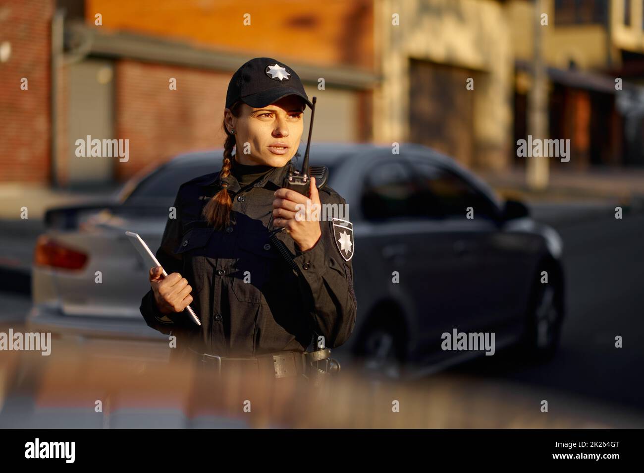Police woman talking using walkie-talkie during patrolling Stock Photo ...