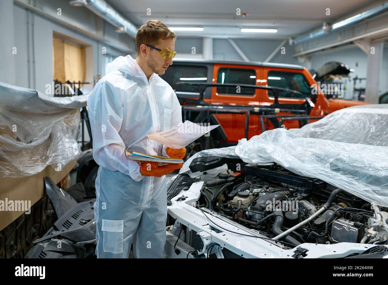 Young man worker examining hi-res stock photography and images - Alamy