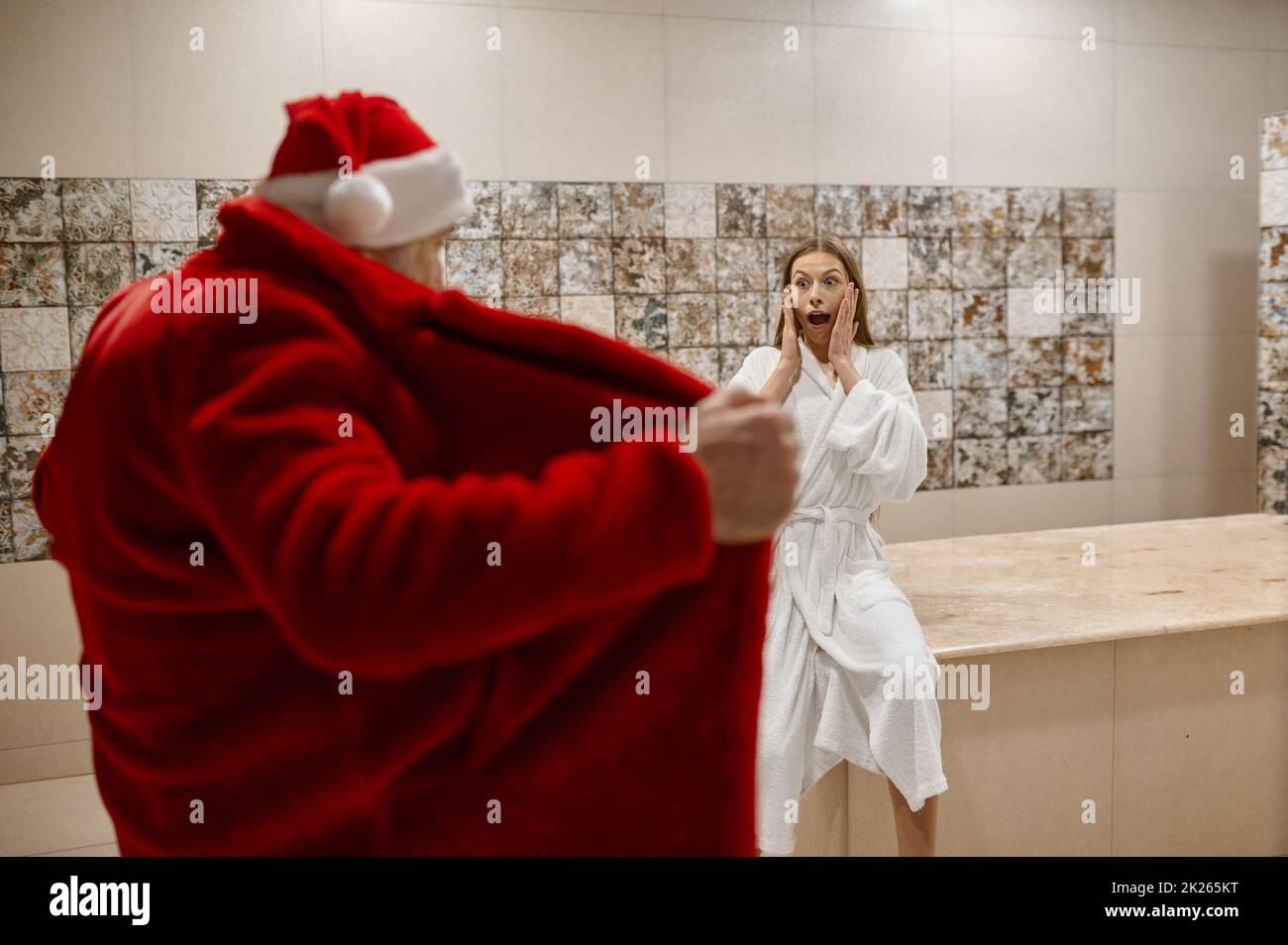 Bad Santa scared woman with open bathrobe Stock Photo - Alamy
