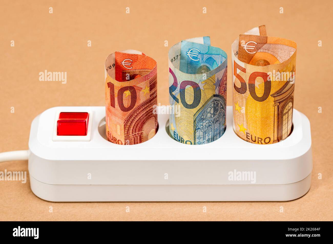 Euro money banknotes inserted into an extension socket Stock Photo - Alamy