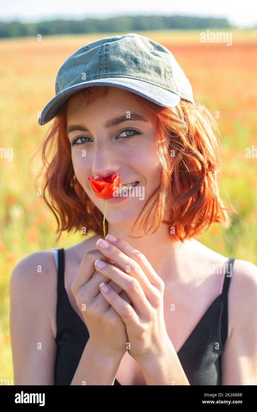 girl with poppy flower in poppy field Stock Photo - Alamy