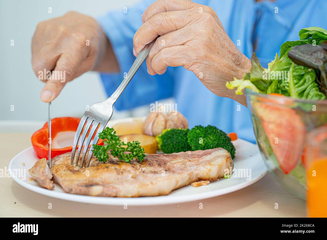 Asian senior or elderly old lady woman patient eating breakfast and ...