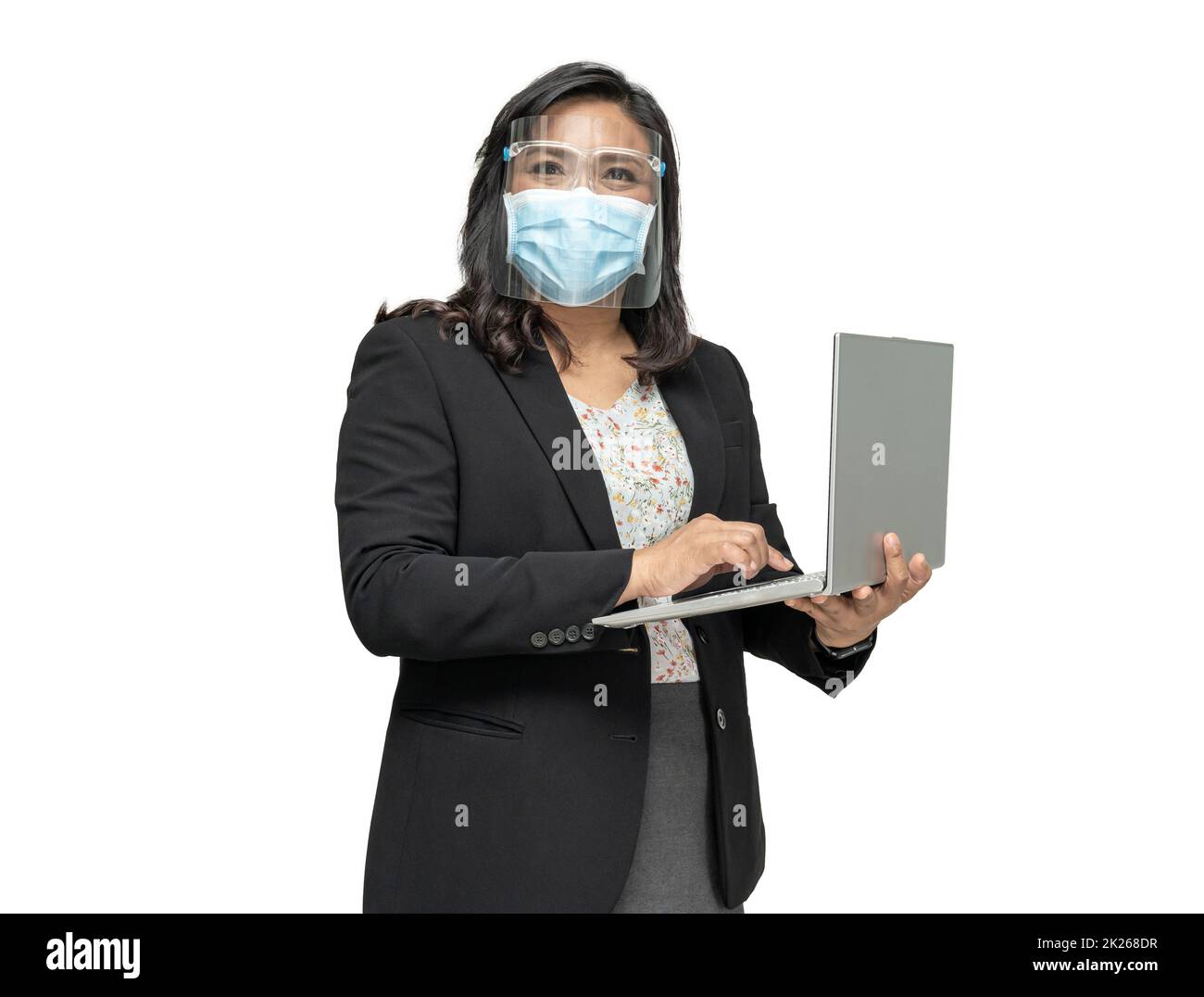 Business asian lady wearing face shield and face mask holding laptop ...