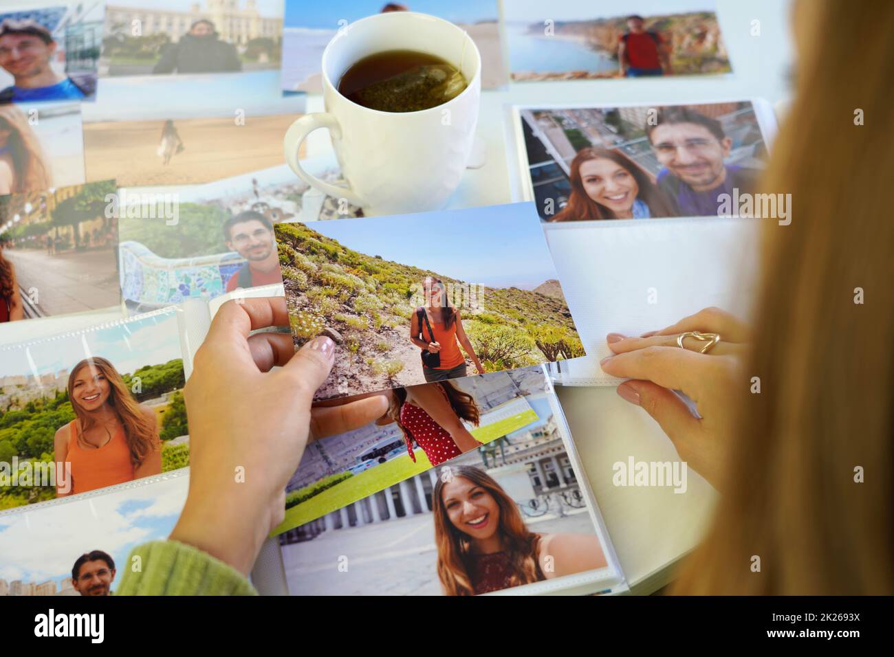 Young woman watching at her printed photos, remember nostalgia for a ...