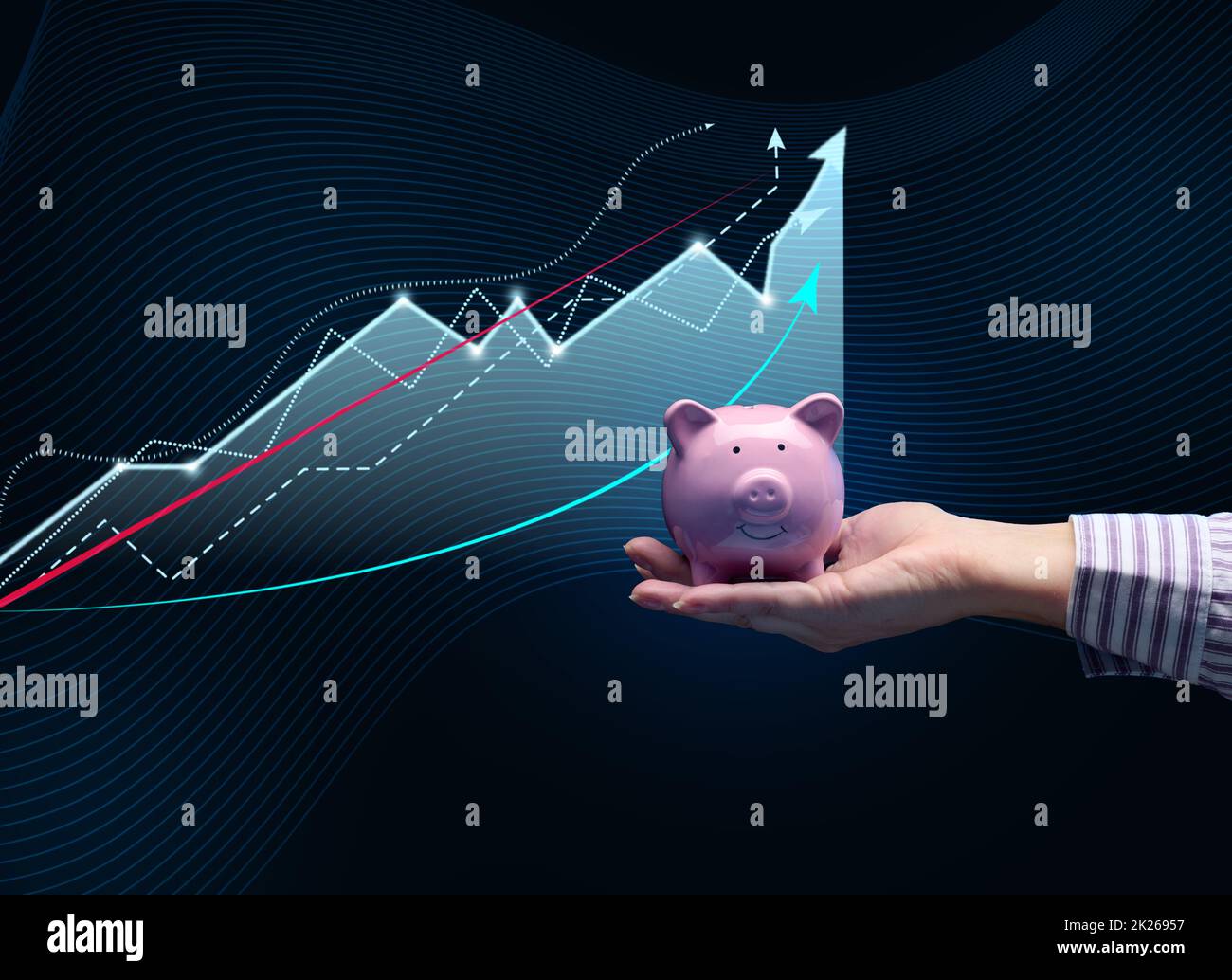 a female hand holds a pink ceramic piggy bank against the background of ...