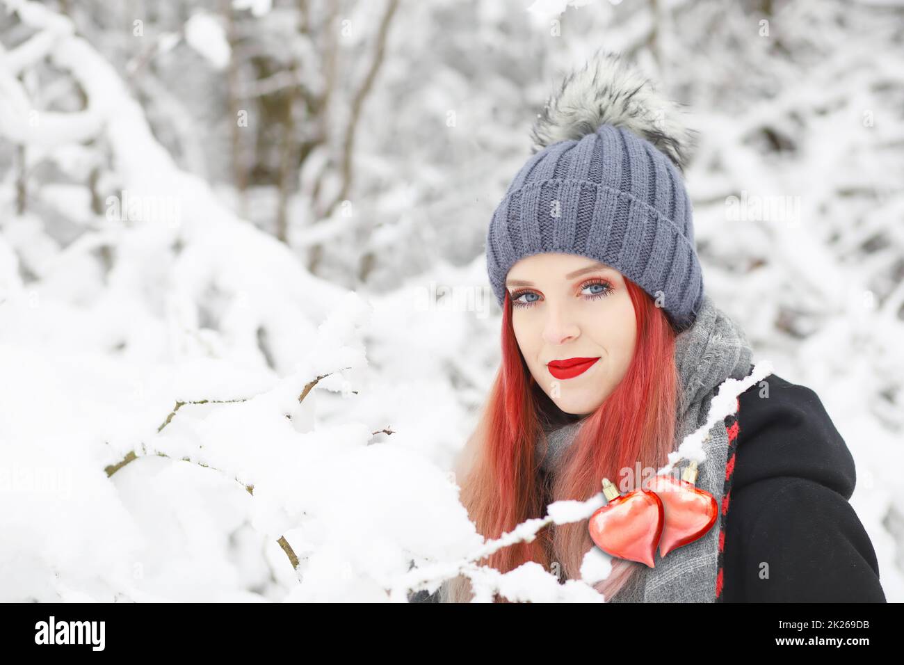 Beautiful red hair girl posing with two red hearts in winter Stock ...