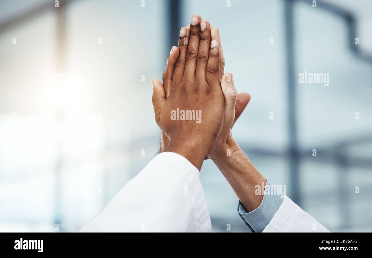 Success, high five and winner doctors celebration with teamwork, support and collaboration in ...