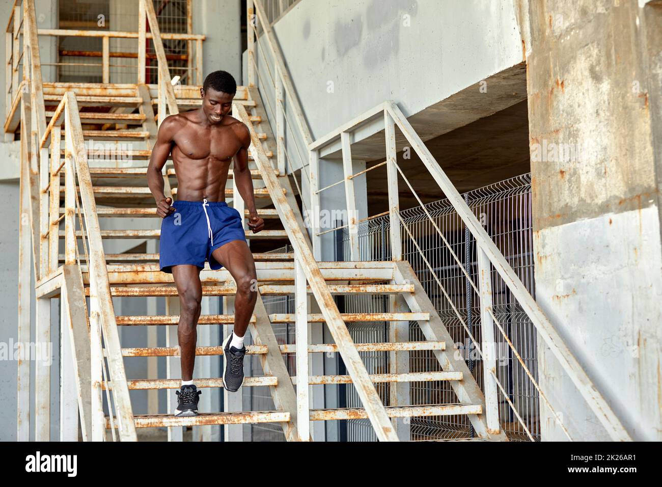 Black man running up stairs hi-res stock photography and images - Alamy
