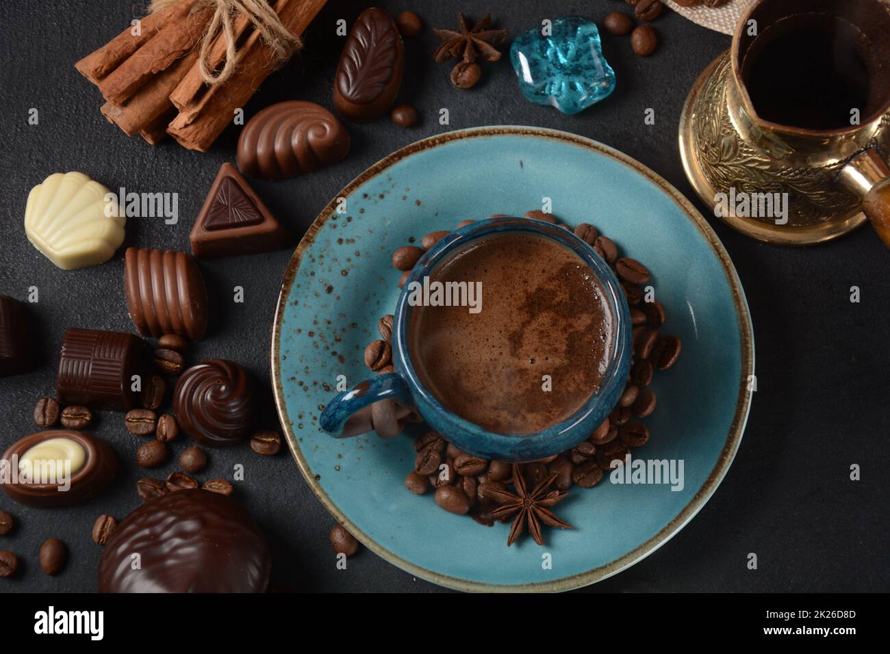 Coffee cup, beans, chocolate on old kitchen table Assortment of dark ...