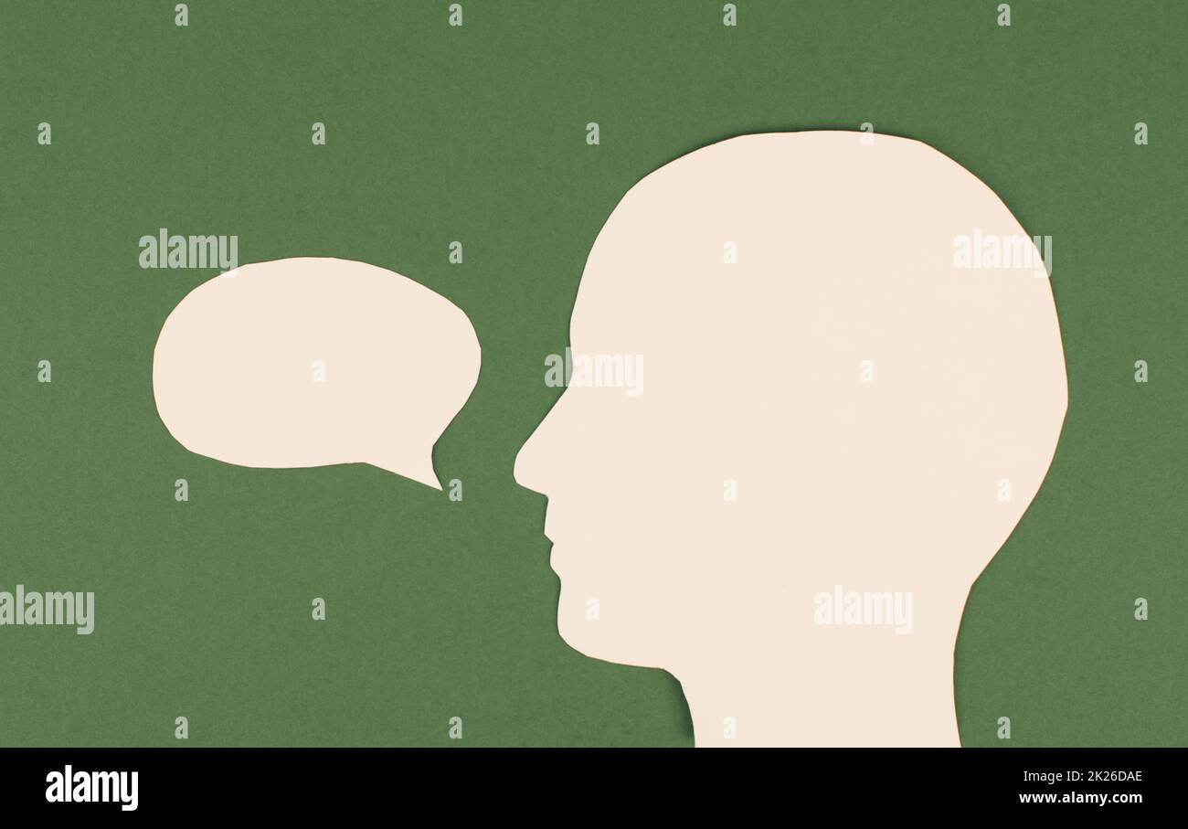 Silhouette of a face, speech bubble in white color, copy space for text ...