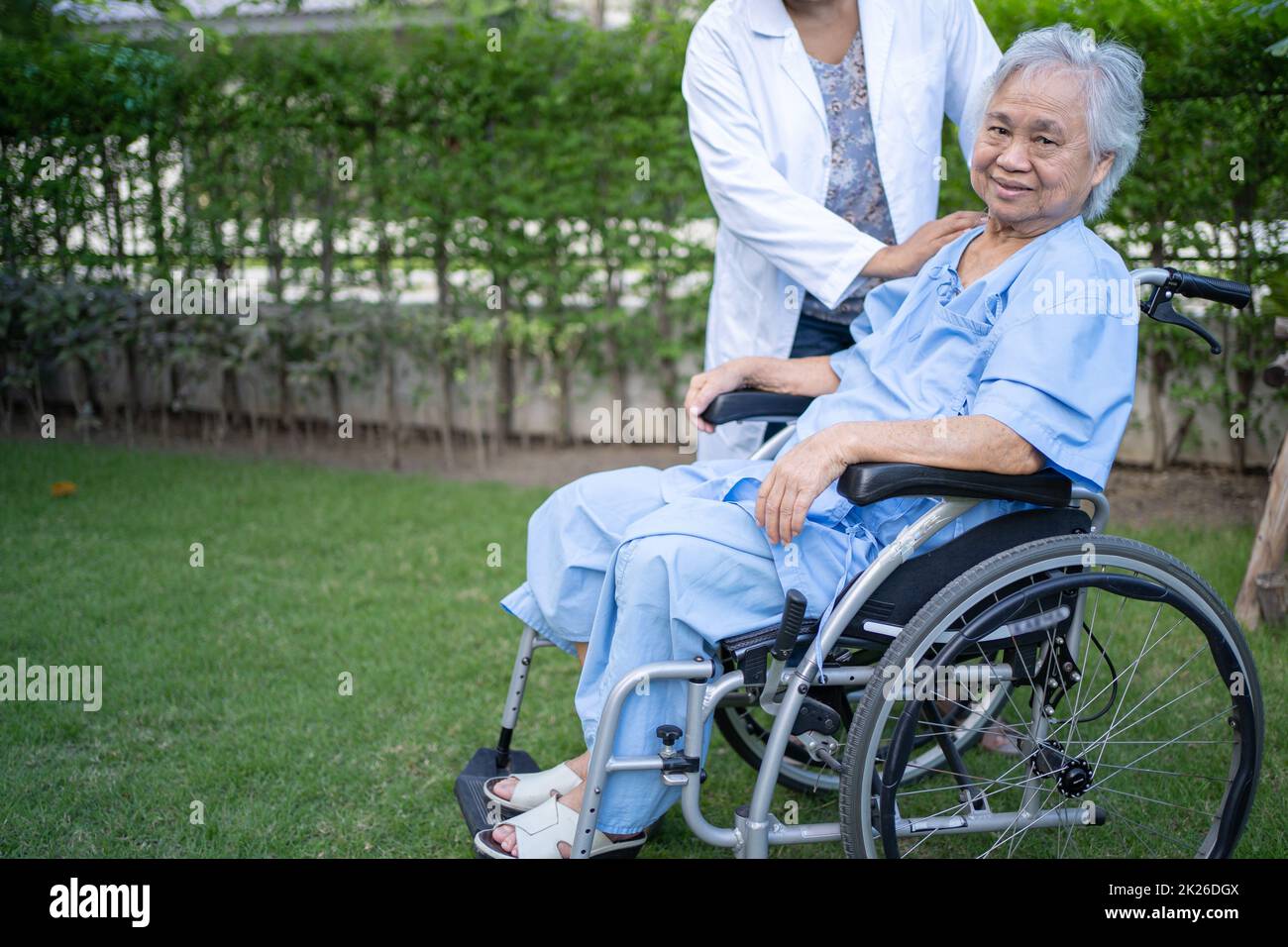 Doctor help and care Asian senior or elderly old lady woman patient sitting on wheelchair at ...