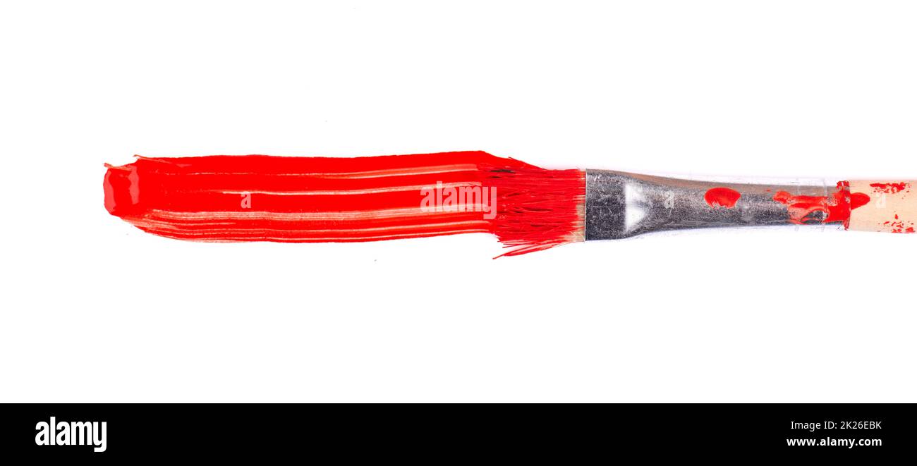 Painting a red line with a brush, white isolated background, copy space ...