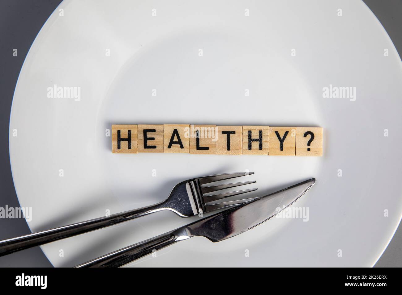 White plate with the words Healthy and a question mark top view with ...