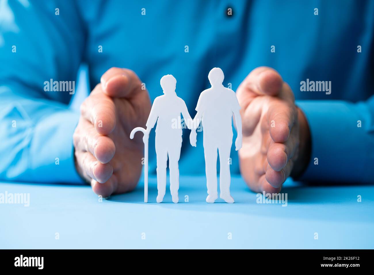 Hand Protecting Senior Couple Cutout Figures Stock Photo - Alamy