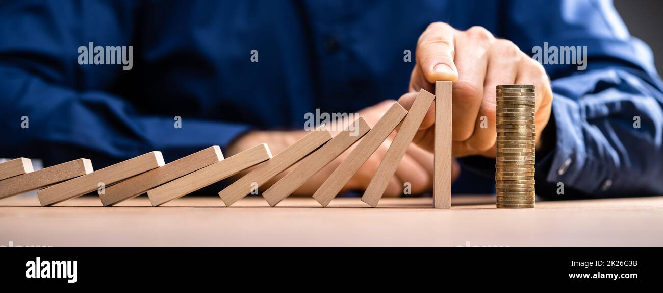 Business Risk. Hand Stopping Falling Domino Stock Photo - Alamy