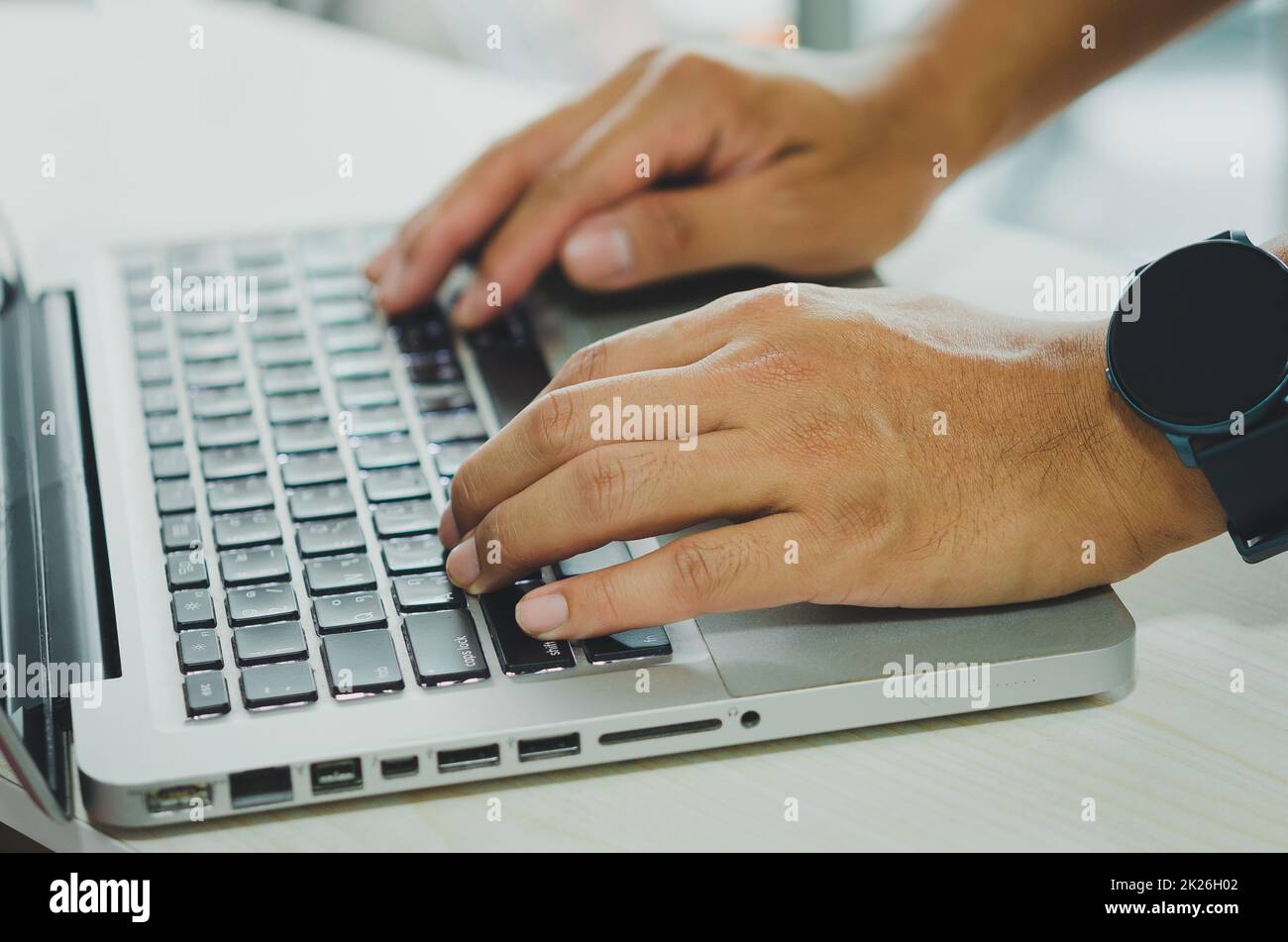 Male hands using computer for information or social media and ...