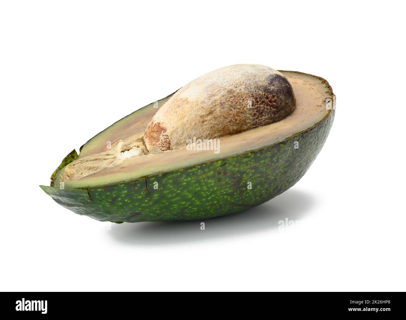 half of rotten avocado with pit on white background Stock Photo - Alamy