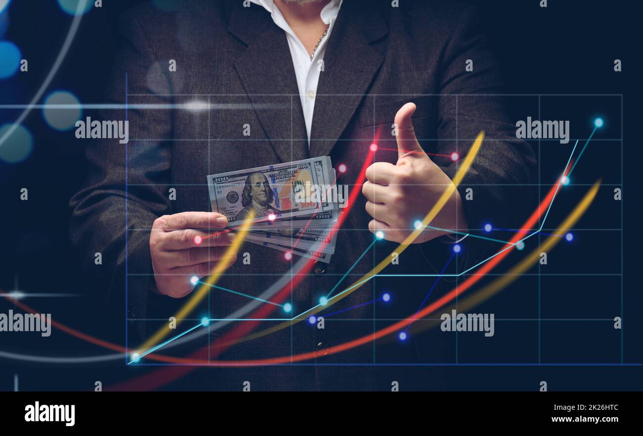 businessman in a suit holds a pack of paper american dollars against ...