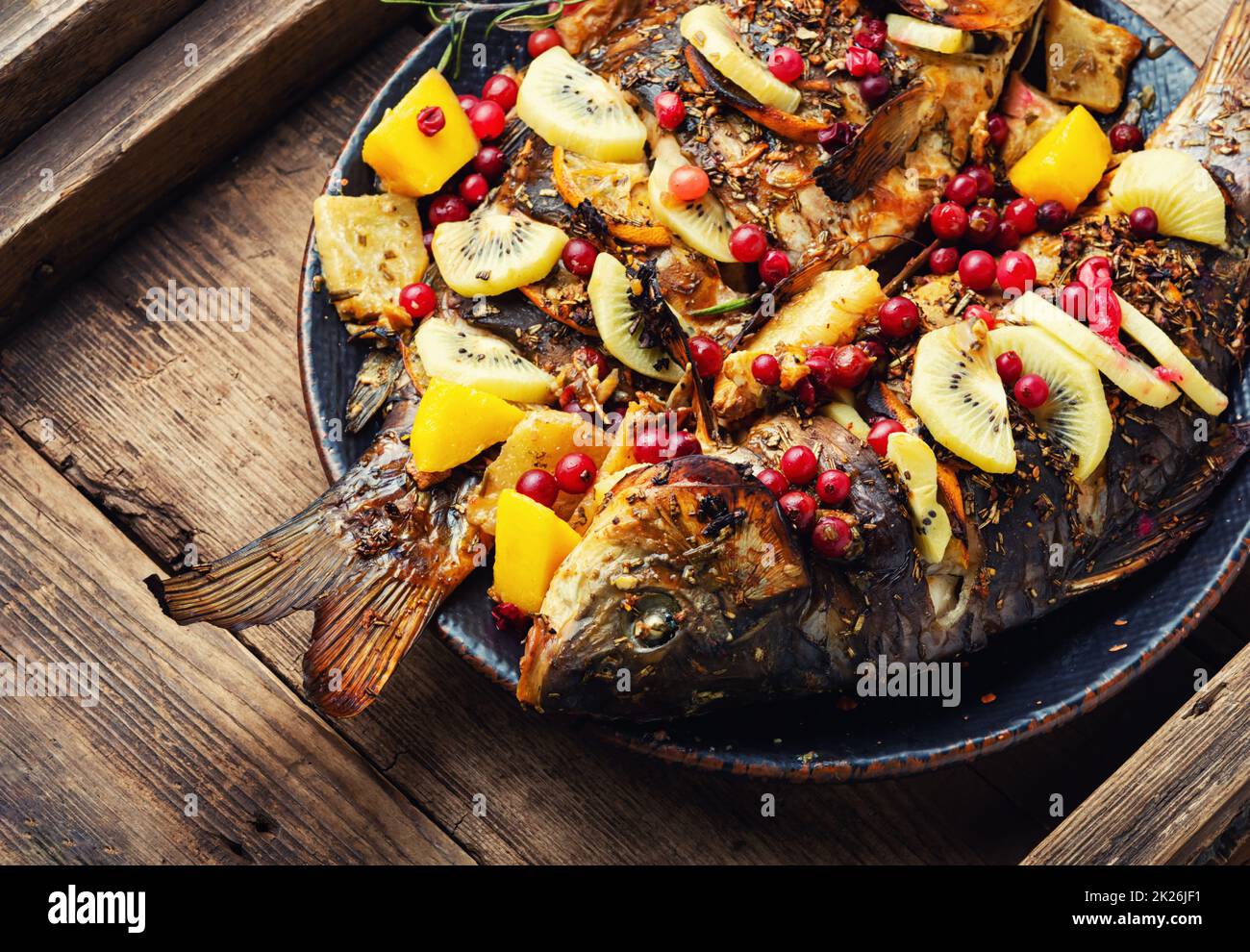 Tasty crucian fried with kiwi and mango Stock Photo - Alamy