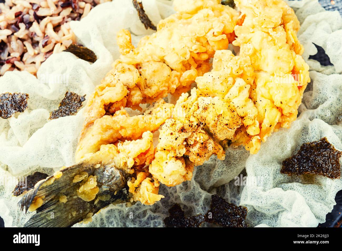 Deep fried sea bass with rice Stock Photo - Alamy