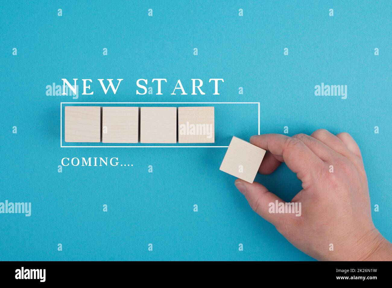 Words new start coming with a loading bar, hand puts last cube to the ...