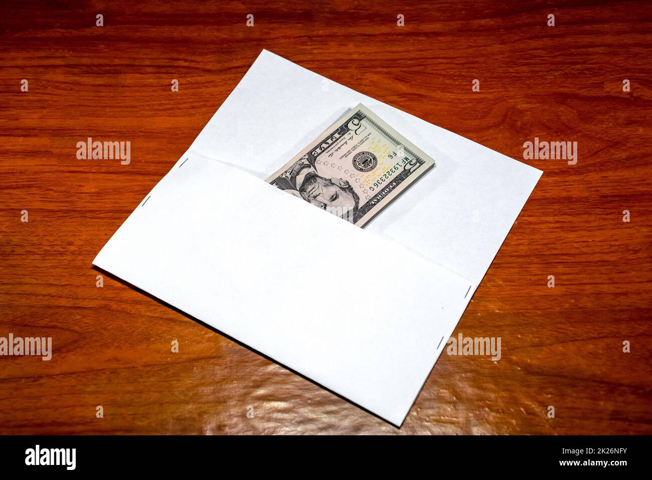 Dollars on table with an envelope. Money in an envelope. U.S. dollars ...