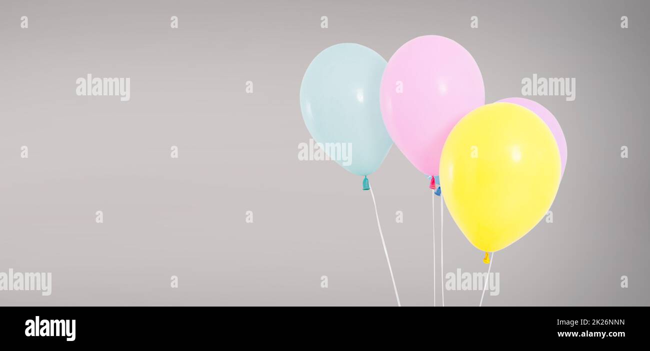 colored helium balloons isolated on grey background, birthday concept ...