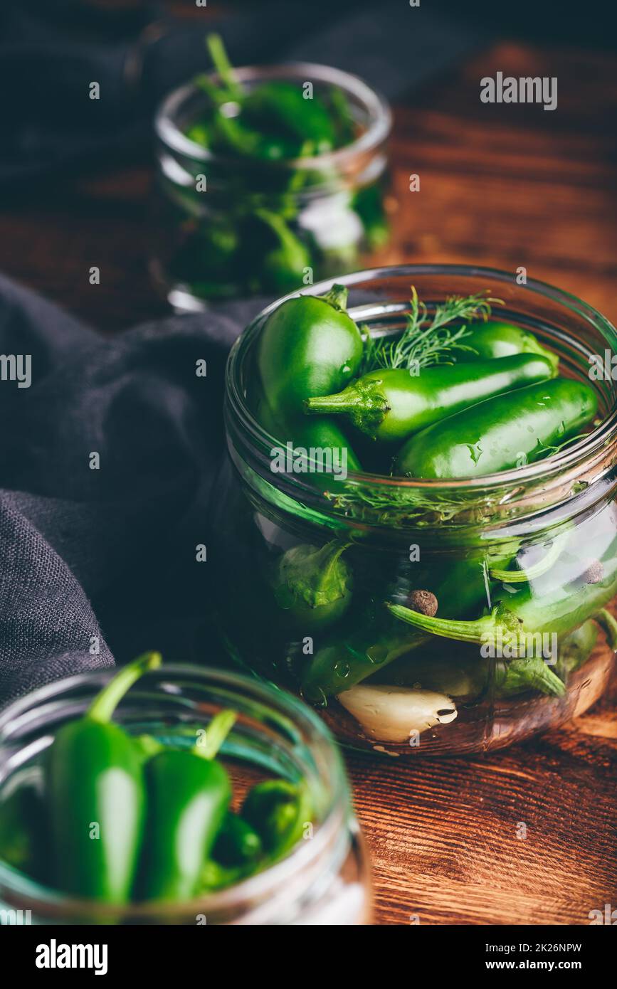 Canned Jalapeno Peppers, Garlic And Dill in Glass Jars Stock Photo - Alamy