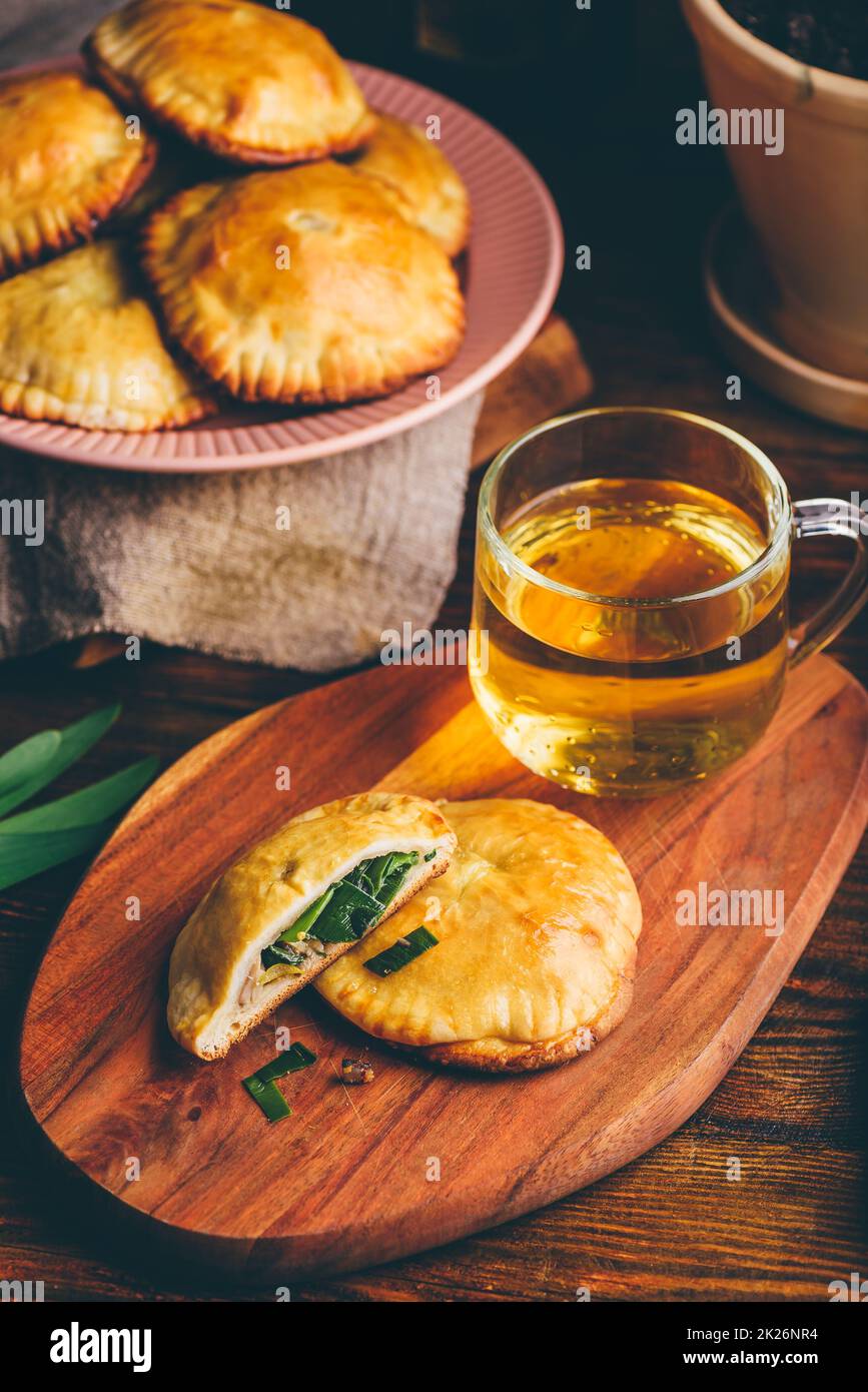 Oven Baked Pastries with Chives and Mushrooms with Cup of Tea Stock ...