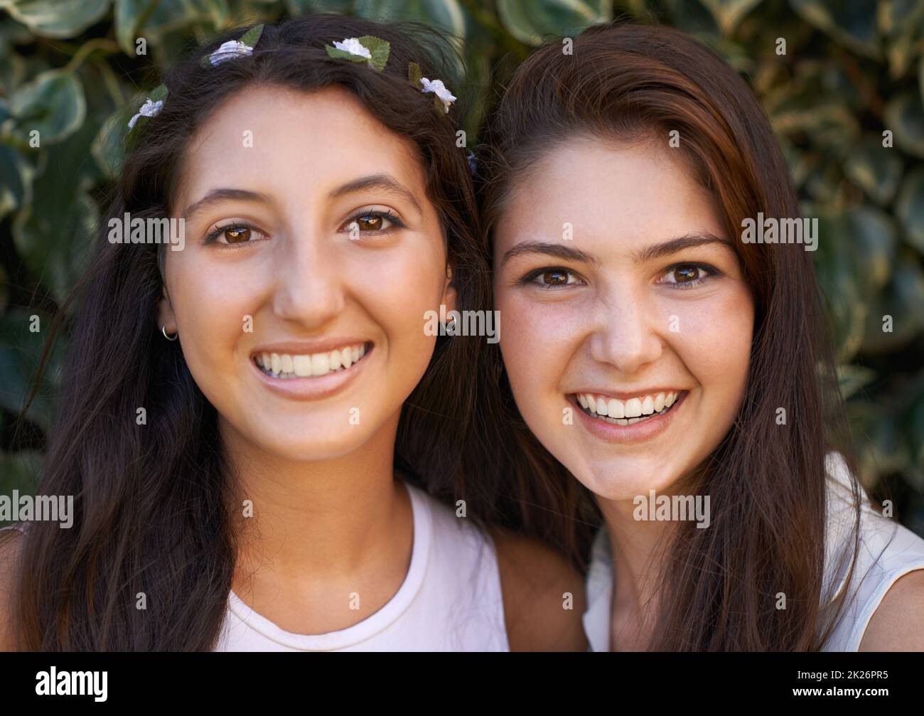 Two peas in a pod. Two young friends smiling happily while spending ...