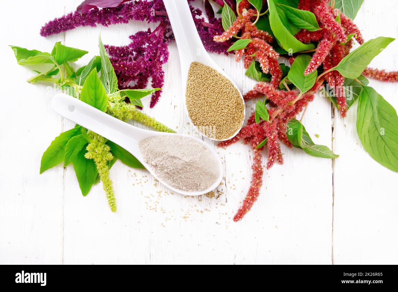 Flour and seeds amaranth in spoons on light board top Stock Photo - Alamy