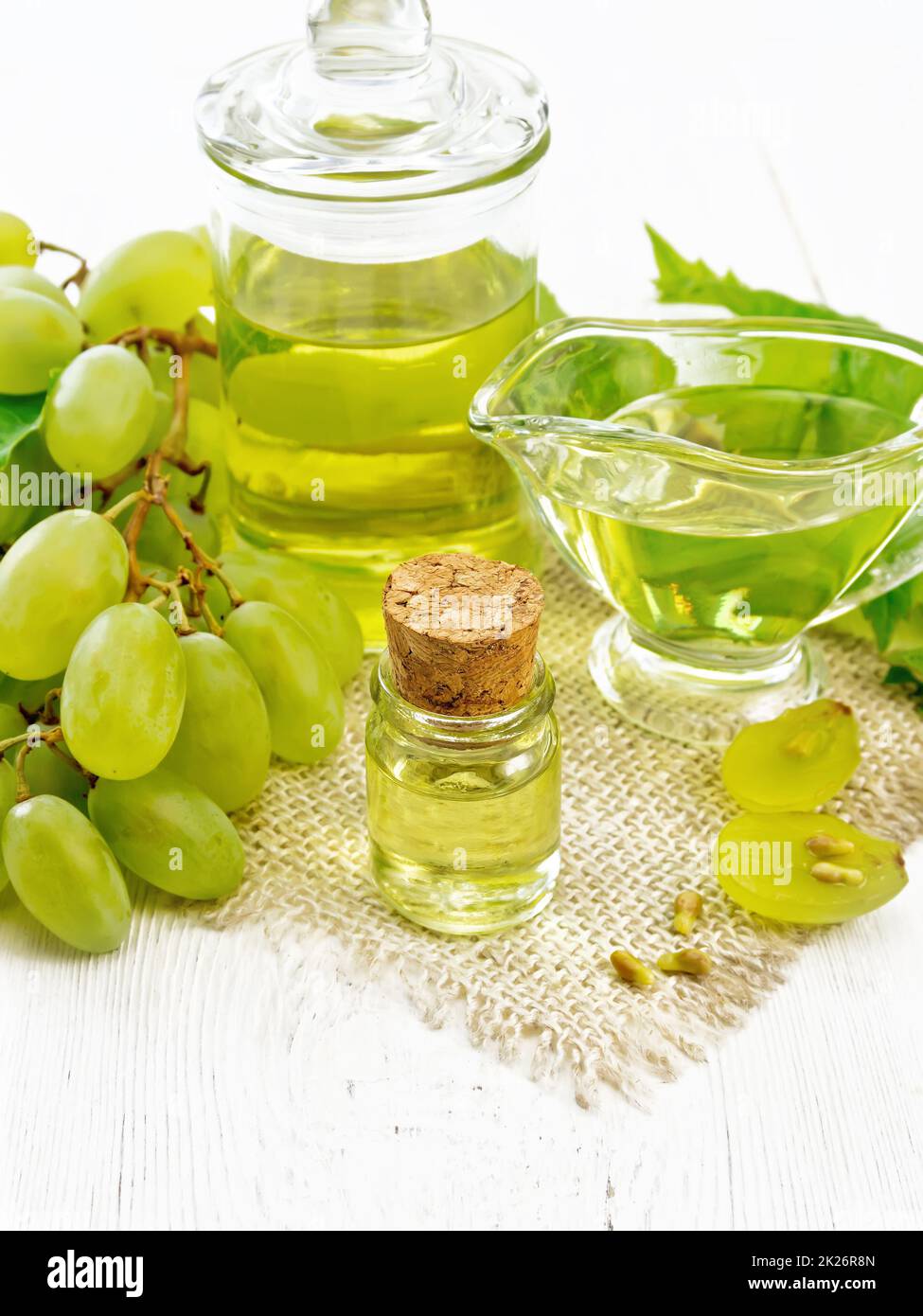 Oil grape in vial on light wooden board Stock Photo - Alamy