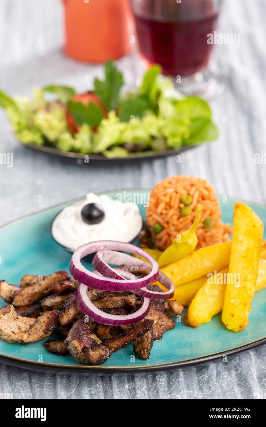 greek gyros on a plate with fries Stock Photo - Alamy