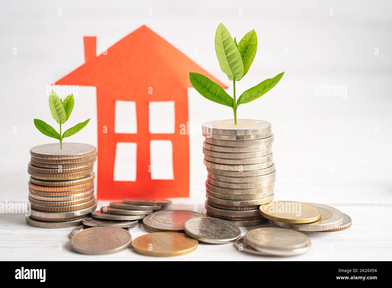 House model with growing plant on stack of coin money, home loan ...