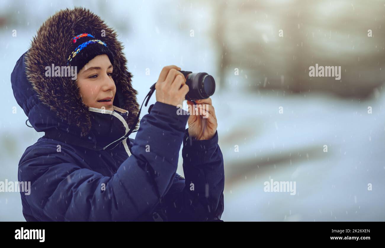 Young Female Taking Pictures in Snowfall Stock Photo - Alamy