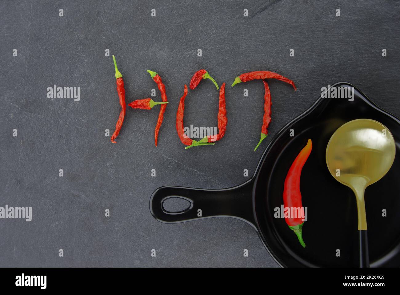 HOT spicy chili pepper still life with text Stock Photo - Alamy