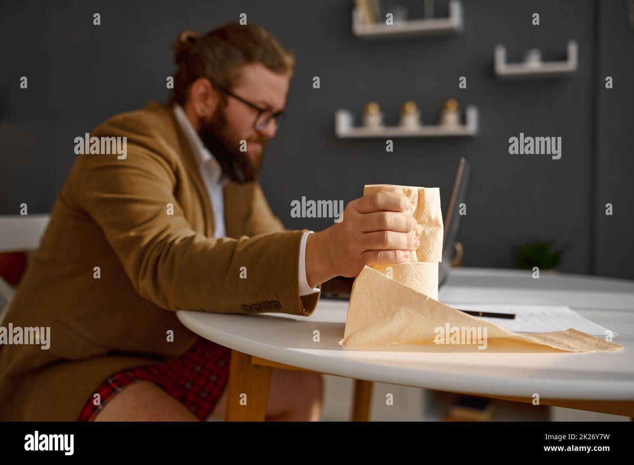 Stressed guy squeeze paper napkin working online Stock Photo - Alamy
