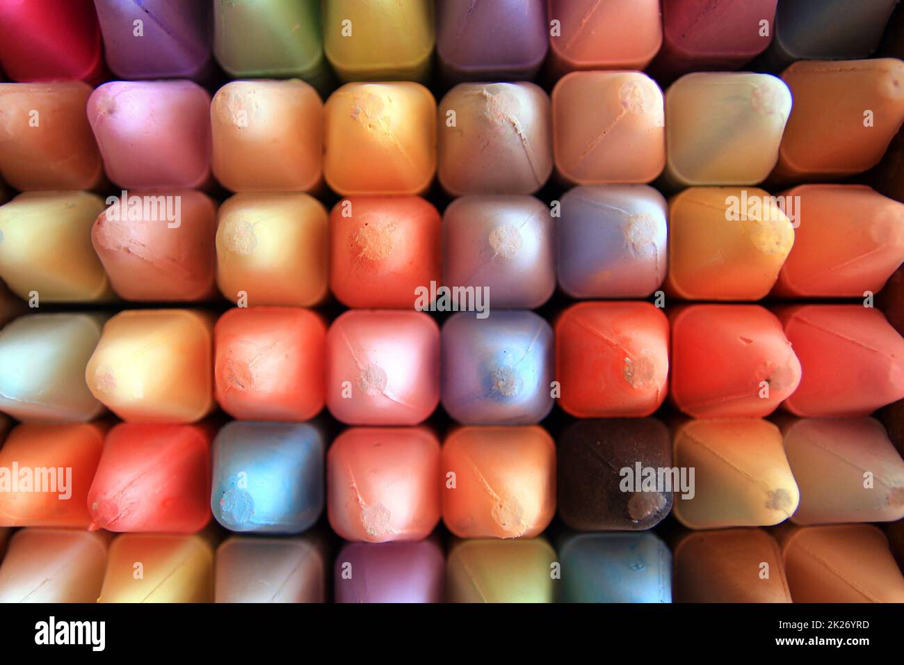 Close up of a set of colored crayons with a square shape and round tip ...