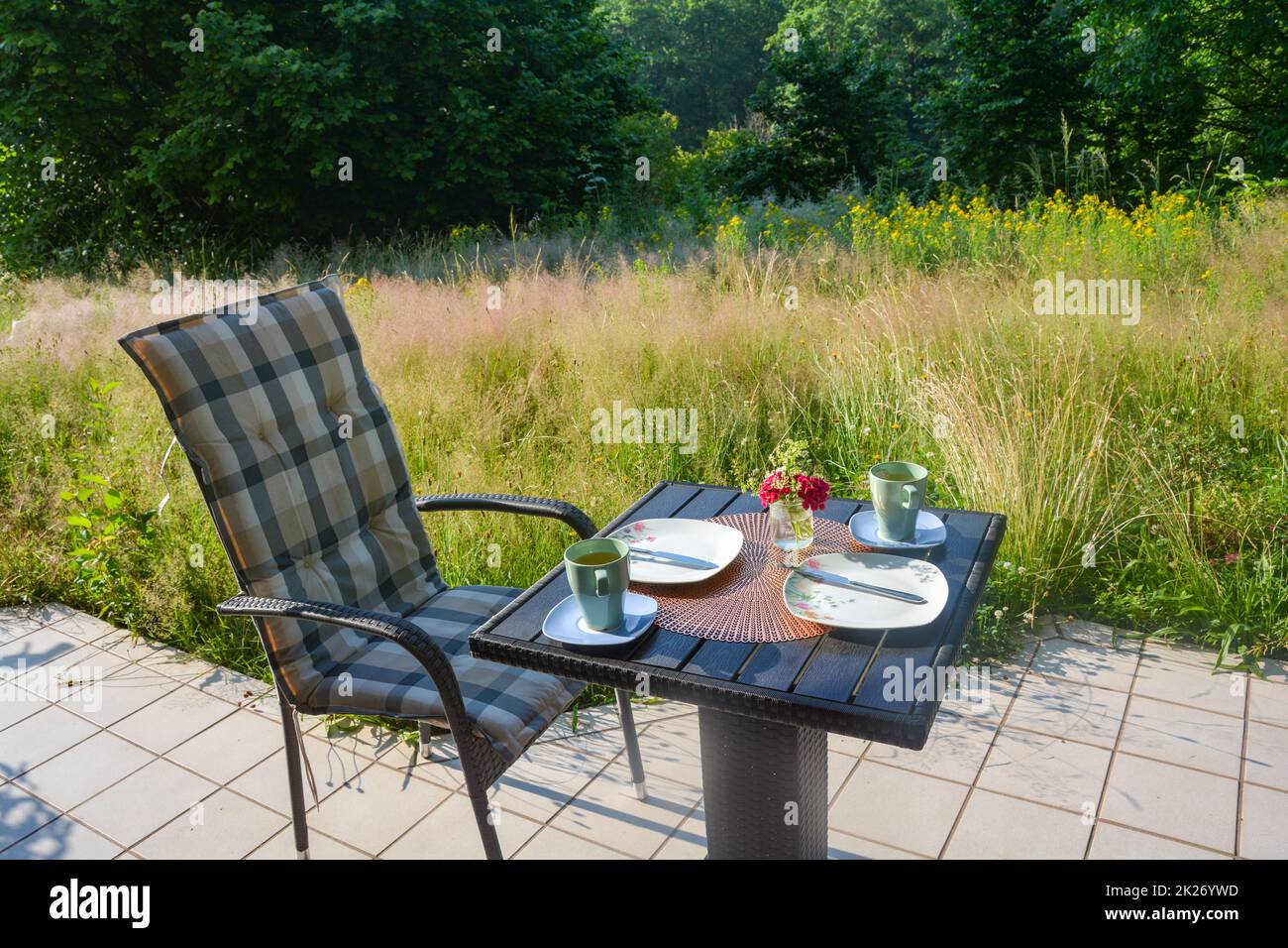 Breakfast on the terrace in front of nature in summer Stock Photo - Alamy