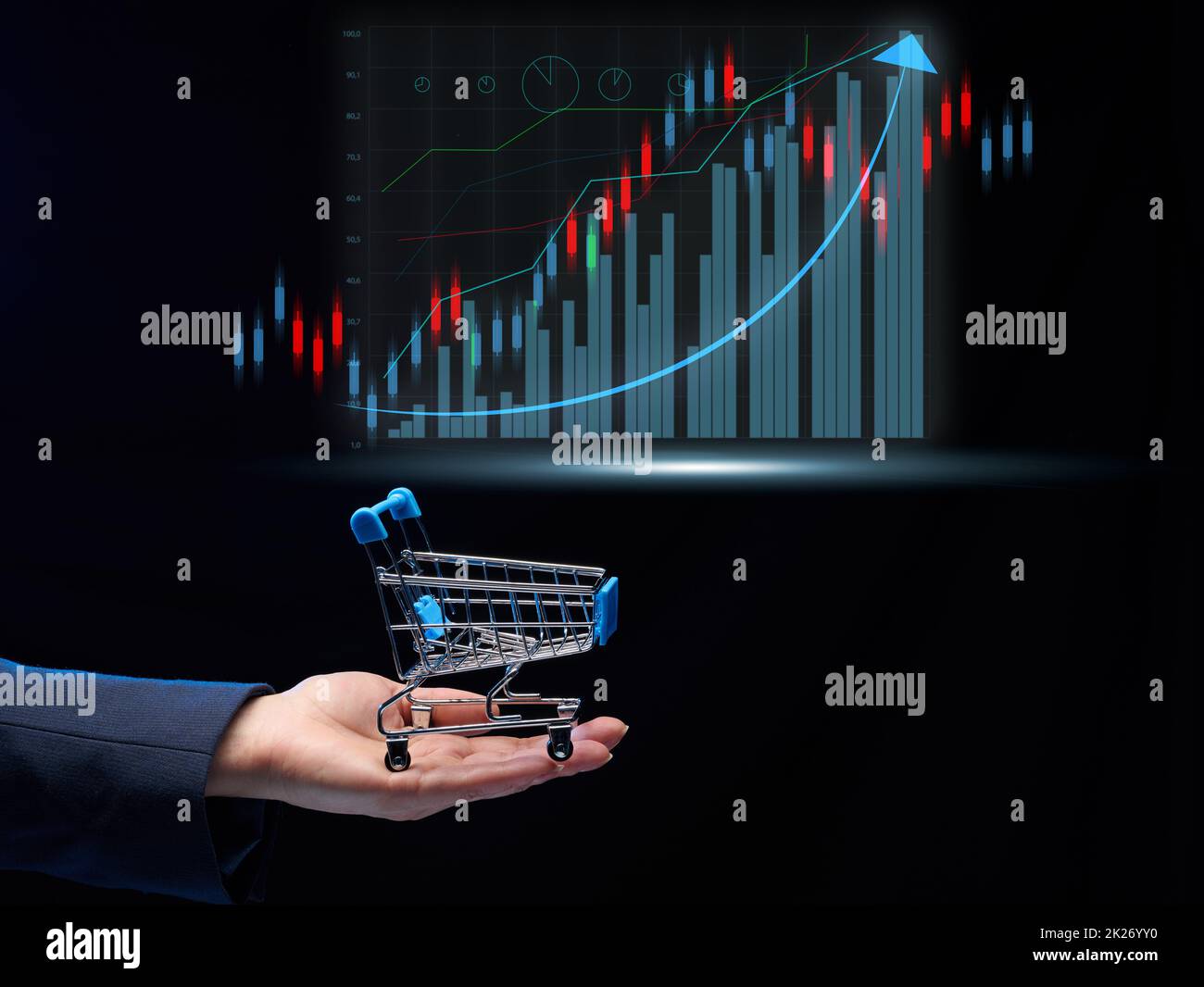 hand holds a miniature shopping cart on a dark blue background, the ...