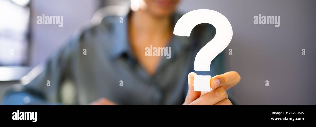 Confused Woman Holding Question Mark Stock Photo - Alamy
